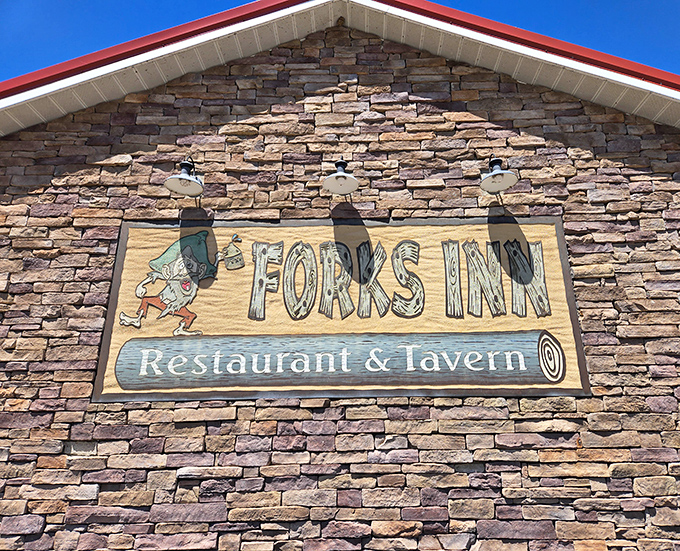 Blue skies frame the Forks Inn sign, a beacon for hungry travelers and a promise of good things to come. That little leprechaun knows what's up.