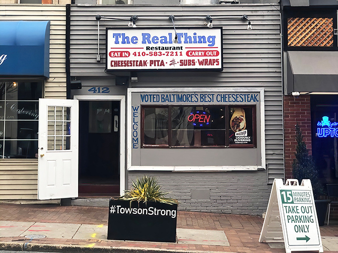 The exterior view showcases the restaurant's straightforward approach. No fancy frills needed when you've got "Baltimore's Best Cheesesteak" in your window.