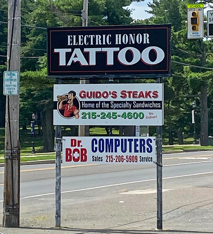 The roadside sign shares space with tattoo artists and computer repair &ndash; a perfect Pennsylvania strip mall trifecta of essential services.