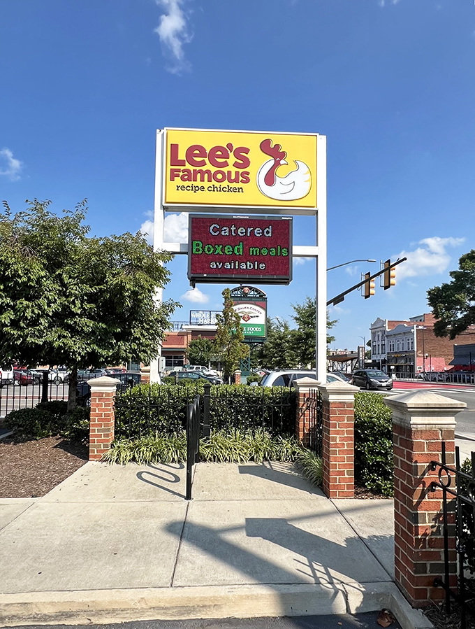 The iconic yellow sign beckons like a lighthouse guiding hungry souls to chicken salvation. Catered boxed meals available—hallelujah!