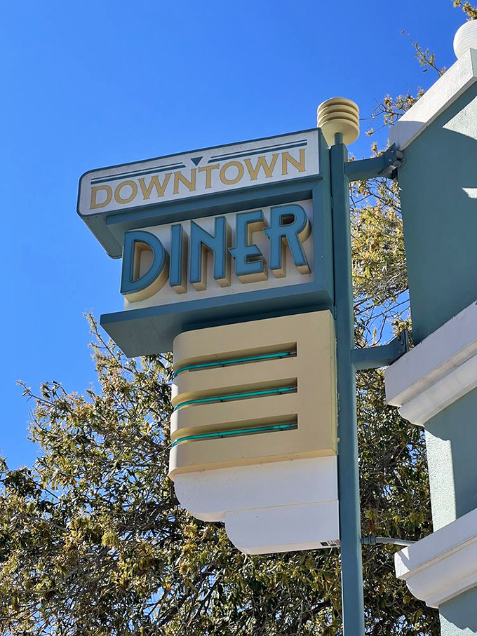 That iconic mint-green and cream sign against the blue Florida sky – a beacon of breakfast hope for hungry travelers and locals alike.