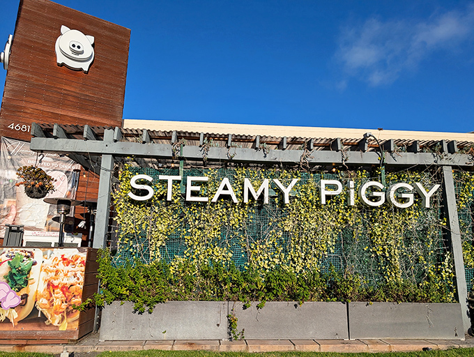 That cheerful piggy logo against a living wall of greenery promises delicious adventures await. Resistance is futile&mdash;and unnecessary.