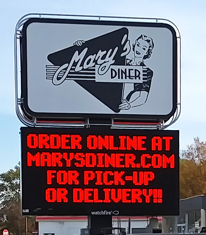 The roadside sign doesn't just advertise&mdash;it announces Mary's Diner with mid-century charm while embracing modern convenience with online ordering options.