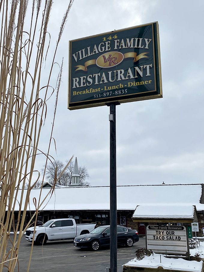 The roadside sign stands tall like a beacon of hope for hungry travelers, promising three square meals and at least one life-changing dessert experience.