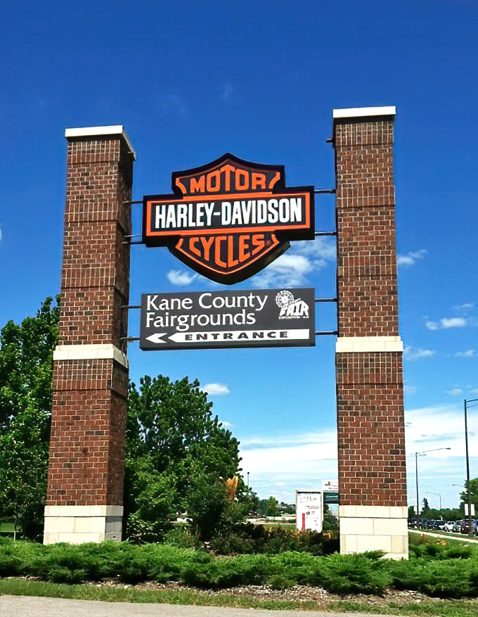 The iconic entrance to Kane County Fairgrounds stands tall, a brick-and-mortar invitation to the treasure hunt that awaits beyond.