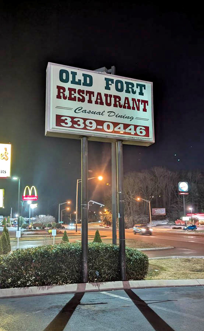 The roadside sign stands tall against the night sky, a North Star for those seeking honest food without pretension or gimmicks.