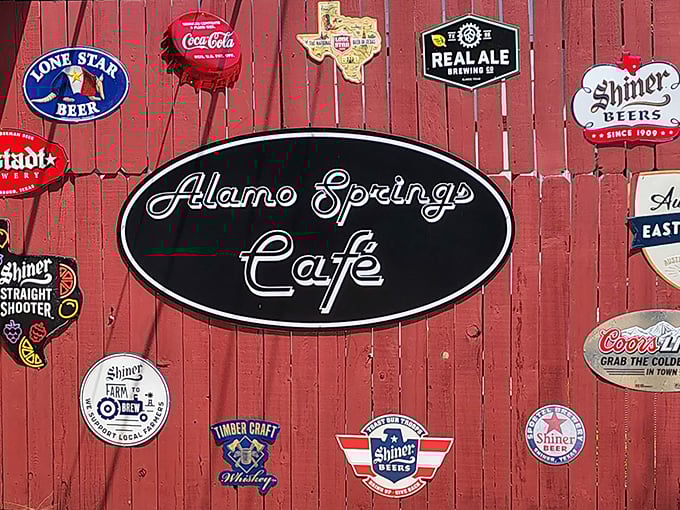 That red fence adorned with beer signs isn't just decoration—it's a Texas roadside gallery celebrating the state's proud brewing heritage.