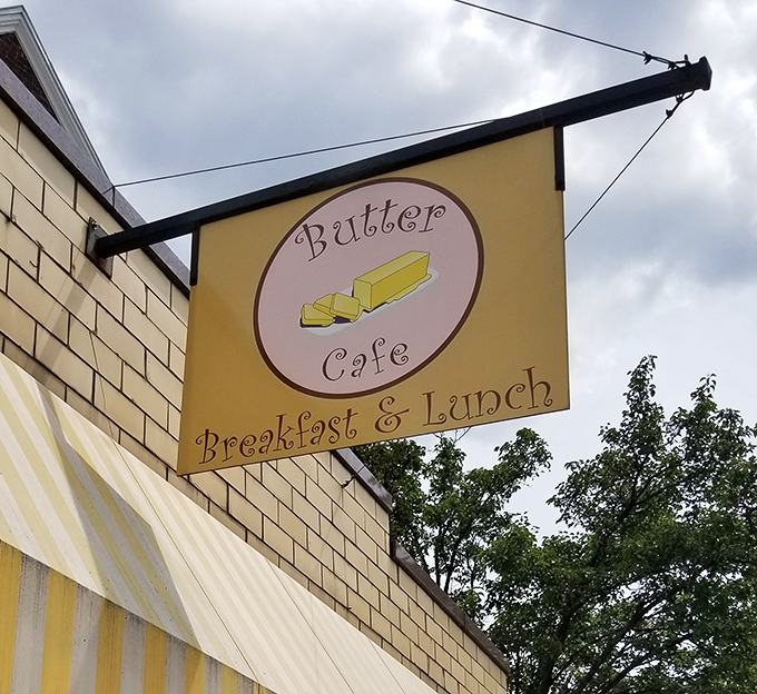 The charming sign swinging above the yellow awning is like a beacon for breakfast lovers&mdash;follow it to find your morning bliss.