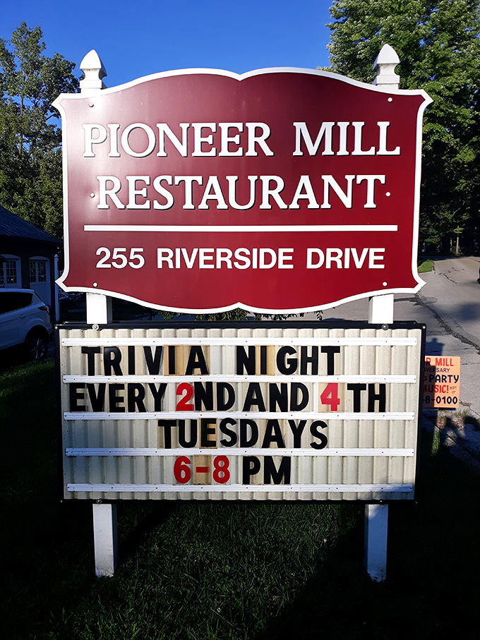 The roadside sign announces not just a restaurant but a community gathering spot where trivia nights add brain food to the menu.