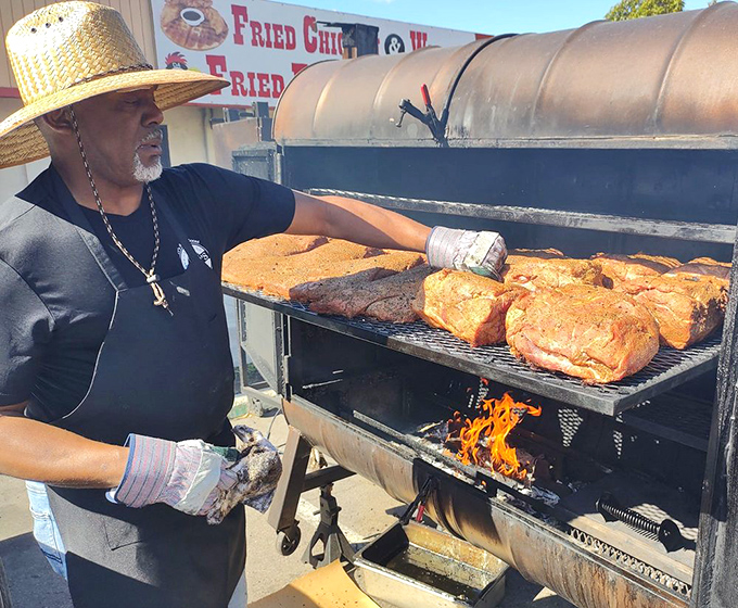 The pitmaster at work&mdash;part scientist, part artist, all dedication. This is barbecue as religion, and the smoker is the altar.