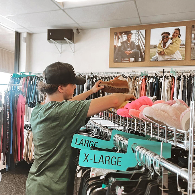 The careful curator at work, arranging merchandise with the precision of a museum director who really understands budget constraints.