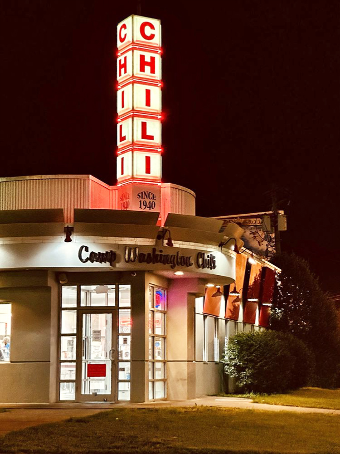 By night, the neon CHILI sign transforms into a beacon of hope for late-night diners seeking salvation in a Coney dog.