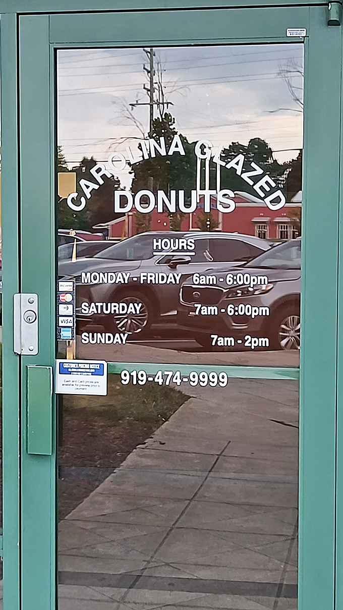 The door tells you everything you need to know: when to arrive for maximum donut freshness. A schedule worth setting your alarm for.