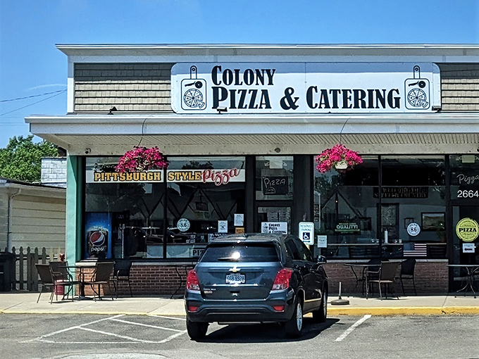 The Colony Pizza sign stands as a landmark for hungry locals who know that Pittsburgh-style pizza is worth the drive.