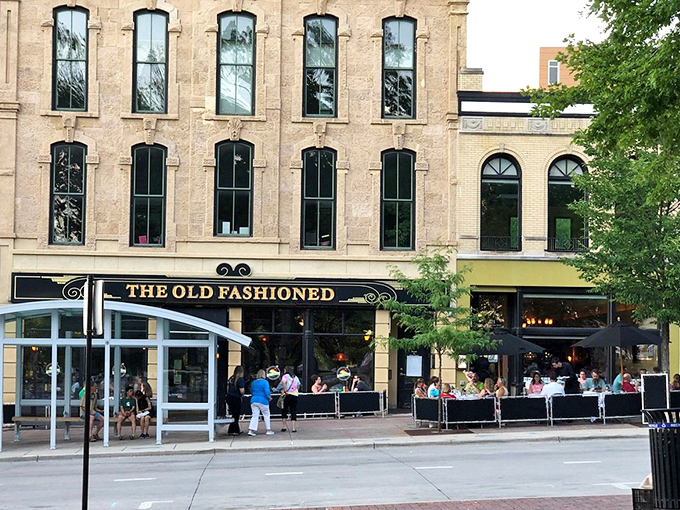 The full fa&ccedil;ade reveals The Old Fashioned in its natural habitat&mdash;where Madison's history meets its appetite. Those windows have seen it all.