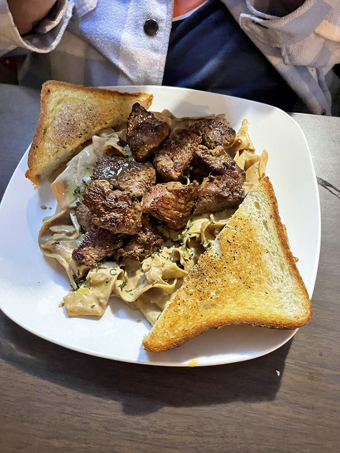 Steak tips over noodles&mdash;comfort food that bridges the gap between fancy and familiar. Those buttery toast points are the perfect sauce-sopping tools.