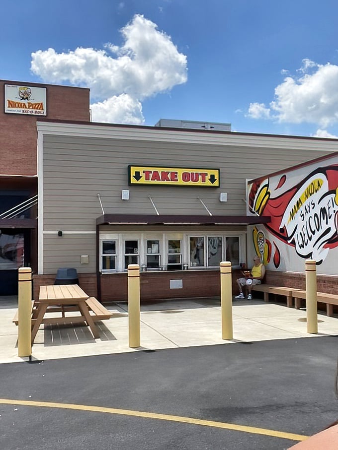The takeout window where dreams come true &ndash; just follow the "WELCOME" sign to pizza paradise.
