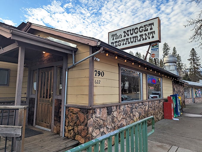 The Nugget Restaurant's stone foundation and wooden deck whisper promises of hearty meals served with a side of local character.