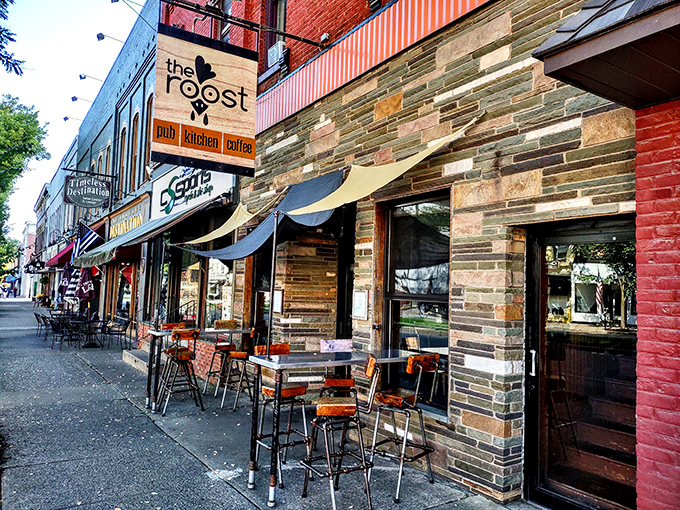 The Roost combines stone fa&ccedil;ade charm with outdoor dining perfection. Those industrial stools aren't just trendy&mdash;they're front-row seats to Wellsboro's daily parade.