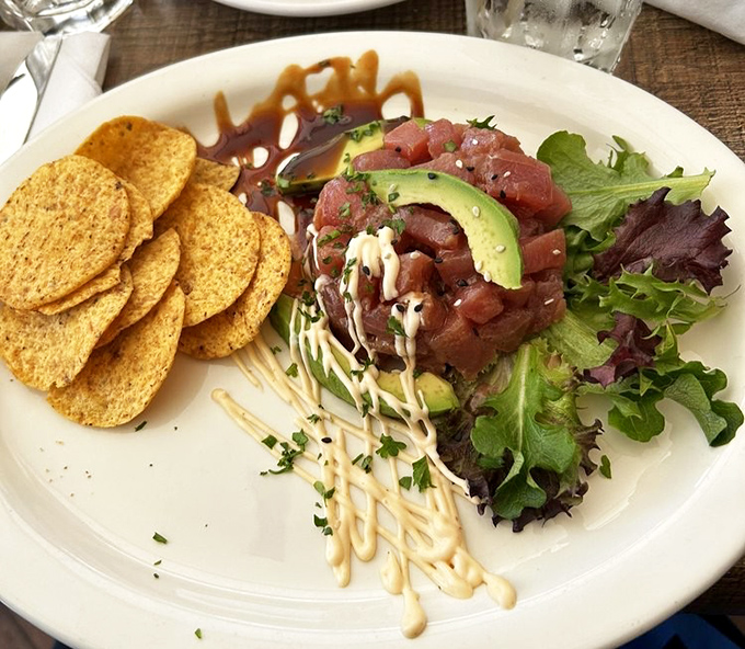 Tuna tartare that's dressed better than most people at Sunday brunch. The avocado crown makes it practically royalty on a plate.