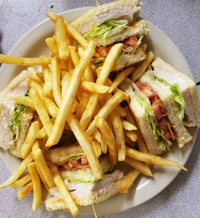 The club sandwich: architectural marvel of the lunch world, where each perfectly cut triangle is a testament to sandwich engineering excellence.