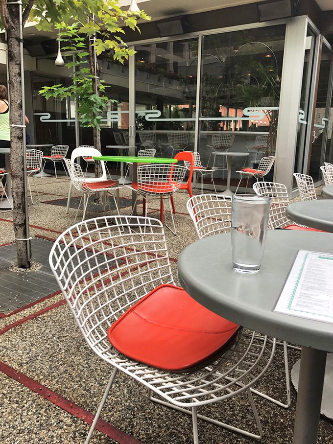 Wire mesh chairs with punchy red cushions offer the perfect perch for sipping cocktails while watching Philly life unfold.