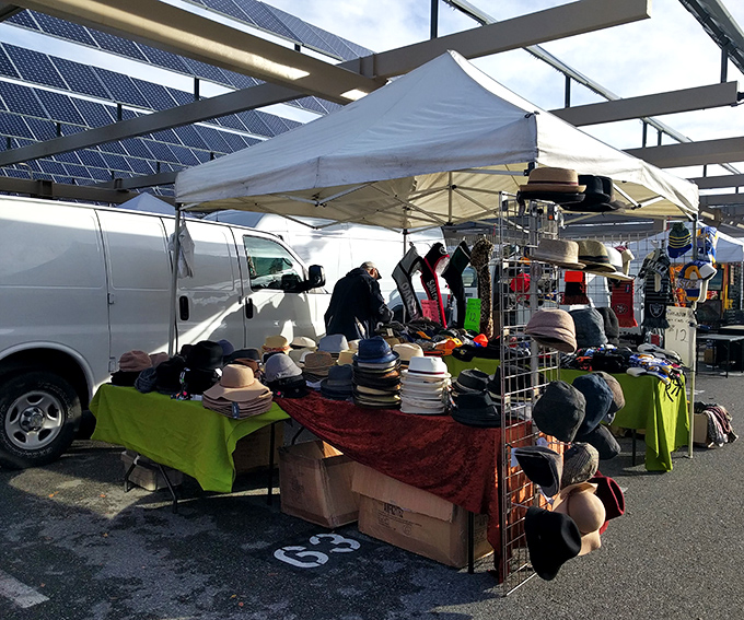 Hat heaven unfolds under white tents, where sun protection meets style in every conceivable design.