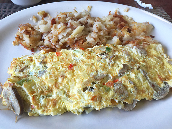 A veggie omelet that proves vegetables can be breakfast heroes too, especially alongside those perfectly crisped home fries.