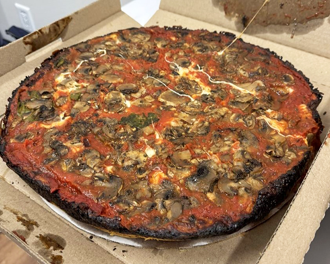 A mushroom lover's dream &ndash; fungi finding their perfect home atop that signature sauce and beneath that blackened cheese halo.