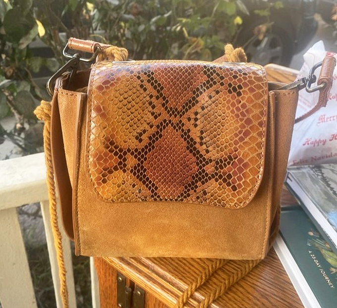 This vintage suede and snakeskin purse isn't just an accessory—it's a time machine to an era when Studio 54 was the place to be seen.