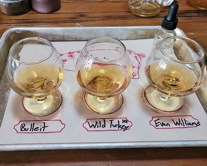 The whiskey flight – three amber pools of liquid courage that stand ready to cut through rich barbecue fat and elevate your meat experience to new heights.