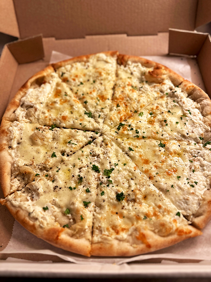 This white pizza proves that sometimes, tomato sauce can take the night off. A blank canvas of cheese becomes a masterpiece of subtle flavors.
