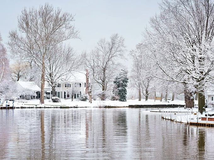 Winter blankets Vermilion's waterfront homes in pristine white, creating a hushed landscape where the river reflects bare trees like nature's artwork.