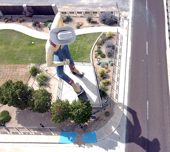 The aerial view reveals Tex's perfect positioning, strategically placed to welcome travelers while anchoring Canyon's identity as cowboy country.
