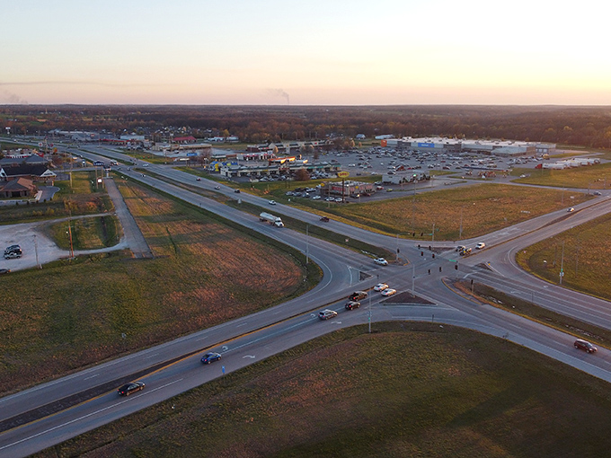 This aerial view reveals Neosho's strategic location at the crossroads of accessibility and affordability—where Social Security checks stretch like yoga instructors.