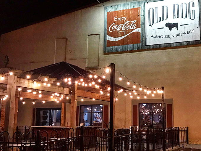 As night falls, the patio transforms under string lights into a magical dining grotto. Even the vintage Coca-Cola sign seems to glow with extra warmth.