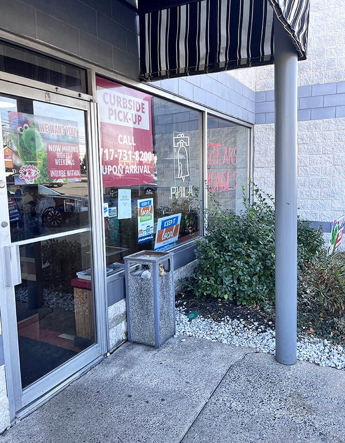 Curbside pickup sign promises cheesesteak convenience. When the craving hits, they've created an escape route for your hunger emergency.