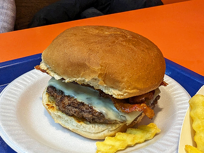 A bacon cheeseburger that makes a compelling argument for simple pleasures. The melted cheese cascading over the patty is pure edible poetry.