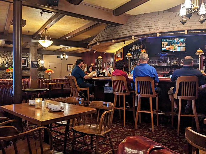 The bar area hums with conversation, a place where strangers become friends and regulars are welcomed like family returning home. 