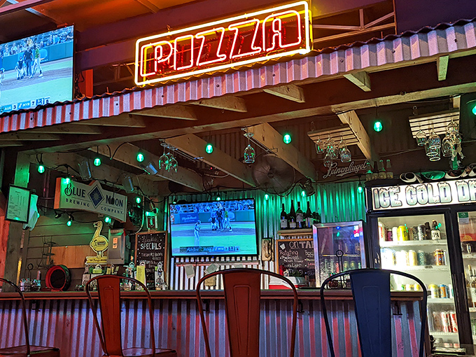 The glowing "PIZZA" sign serves as both beacon and promise&mdash;follow the neon to find your reward of cheese, sauce, and happiness.