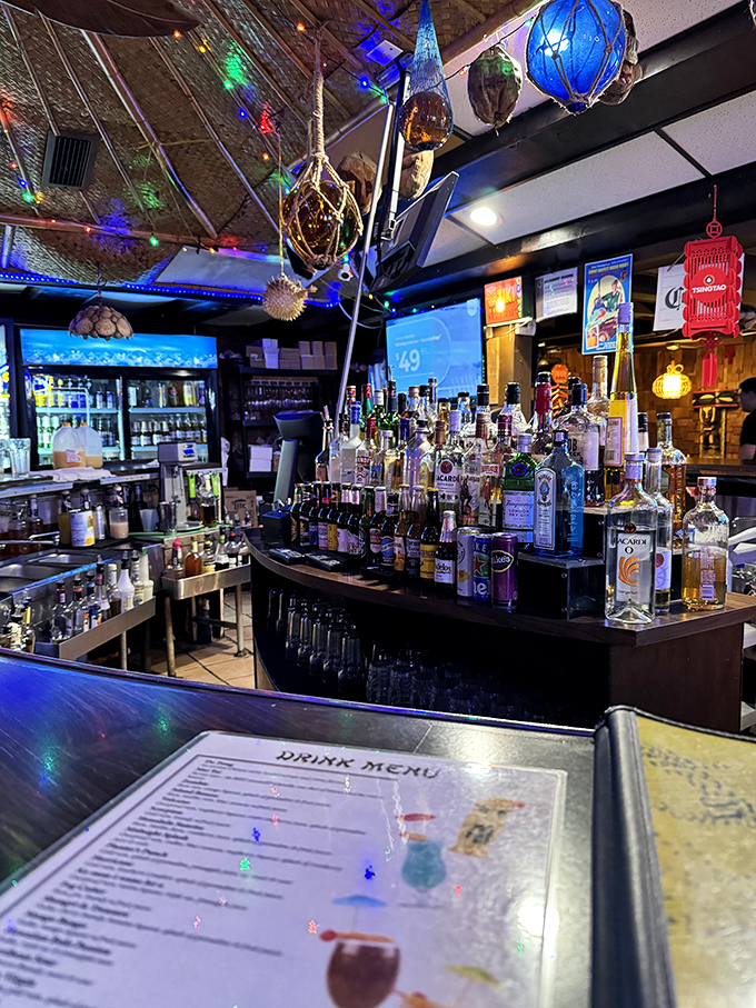 The bar where liquid vacation is served daily. That impressive lineup of bottles isn't just decoration&mdash;it's an arsenal of tropical escape mechanisms.