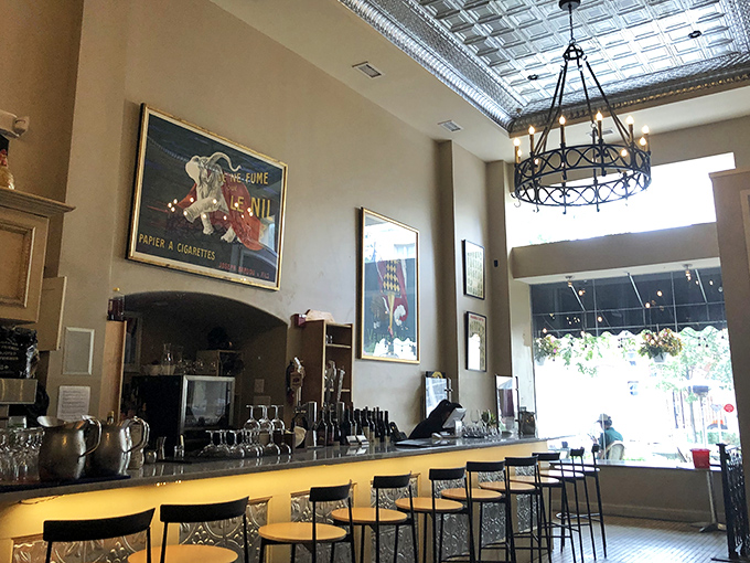 A bar area that invites you to linger over one more glass of wine. Those vintage posters and tin ceiling? They're not trying too hard&mdash;they're just right.