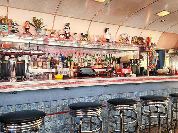 The bar's quirky collection of figurines stands guard over an impressive array of spirits, promising libations as characterful as the decor.