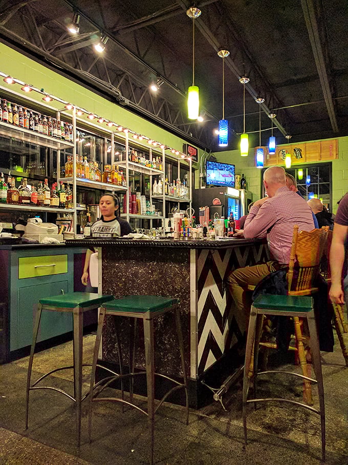 The bar area glows with colorful pendant lights and promises of good times. Where cosmic cocktails meet Cuban-inspired cuisine in perfect harmony.