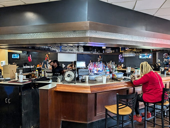 The bar area: where liquid happiness flows freely and strangers become friends over mimosas and shared chicken and waffle experiences.