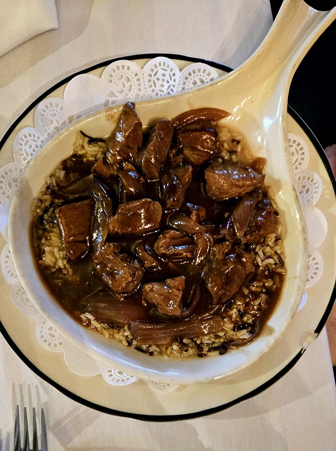 This isn't just beef stew&mdash;it's a hearty time machine in a bowl, served on a doily because even comfort food deserves to dress up occasionally.