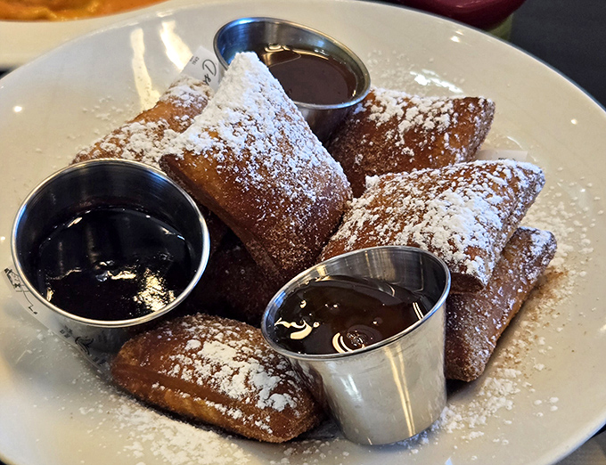 These beignets aren't just dessert&mdash;they're little powdered pillows of joy, served with dipping sauces that make you wonder why you'd ever waste time on lesser sweets. 