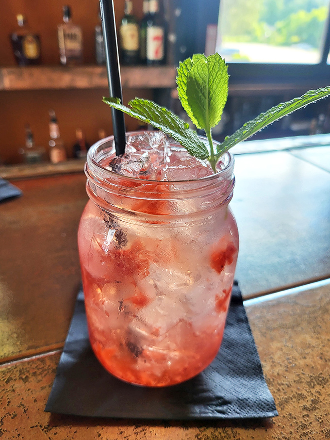 A berry-infused cocktail that's practically wearing a garden on its head. That fresh mint isn't just garnish &ndash; it's aromatherapy with benefits.