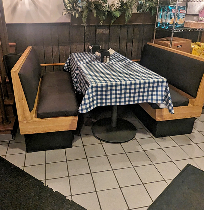 The booth seating offers a front-row view to the cheesesteak show&mdash;where blue checkered tablecloths have witnessed countless first bites and satisfied sighs.