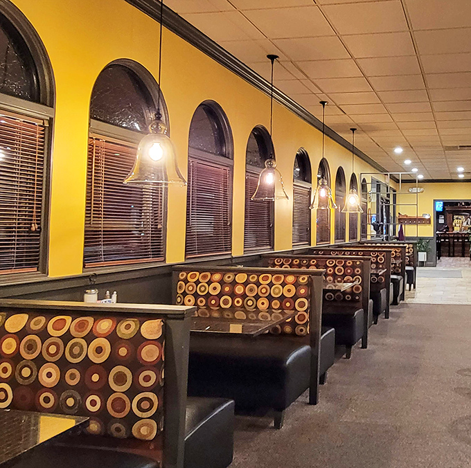 
Cozy booths where food comas are born. Those circular patterns on plush seats invite you to settle in&mdash;your diet can always start tomorrow.